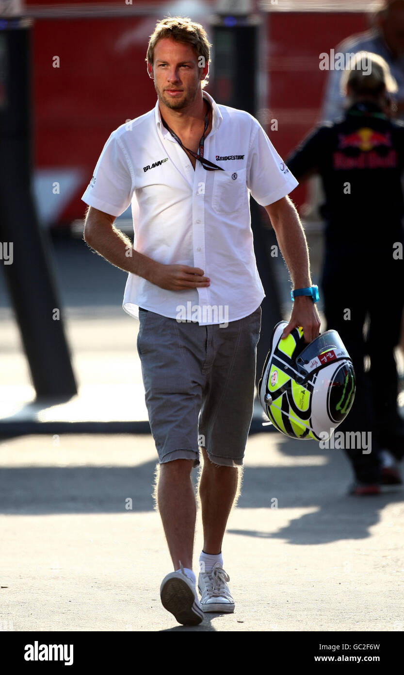 Brawn GP driver Jenson Button arrives in the paddock for first practice ...