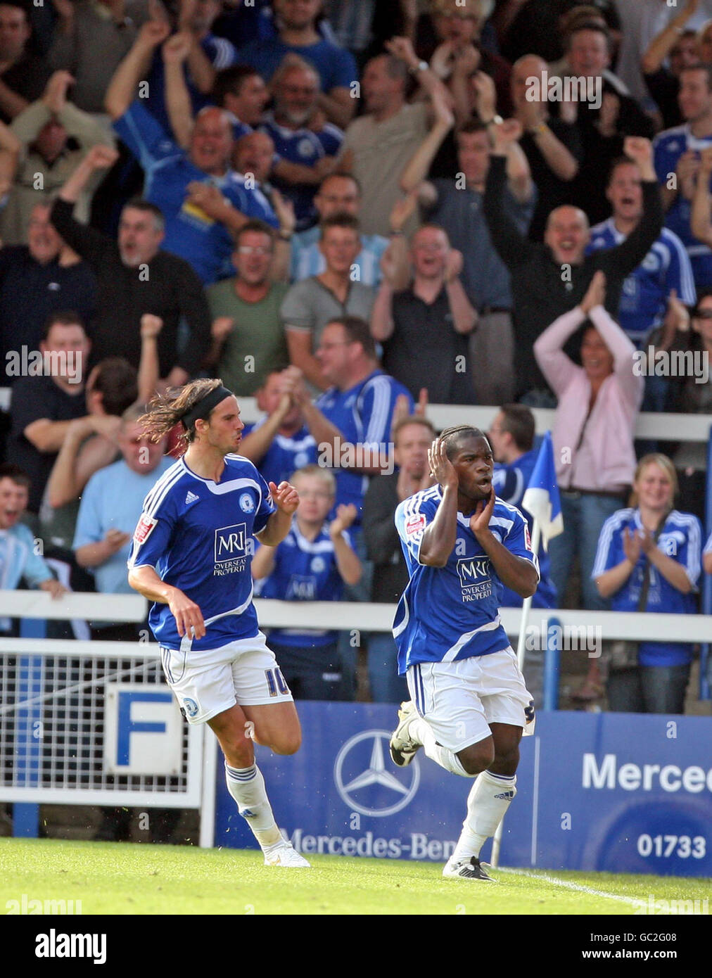 Peterborough United's Aaron McClean (right) celebrates his goal with ...