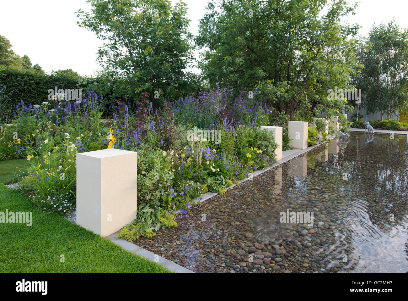 A large water feature, herbaceous borders and dog sculptures in the ...