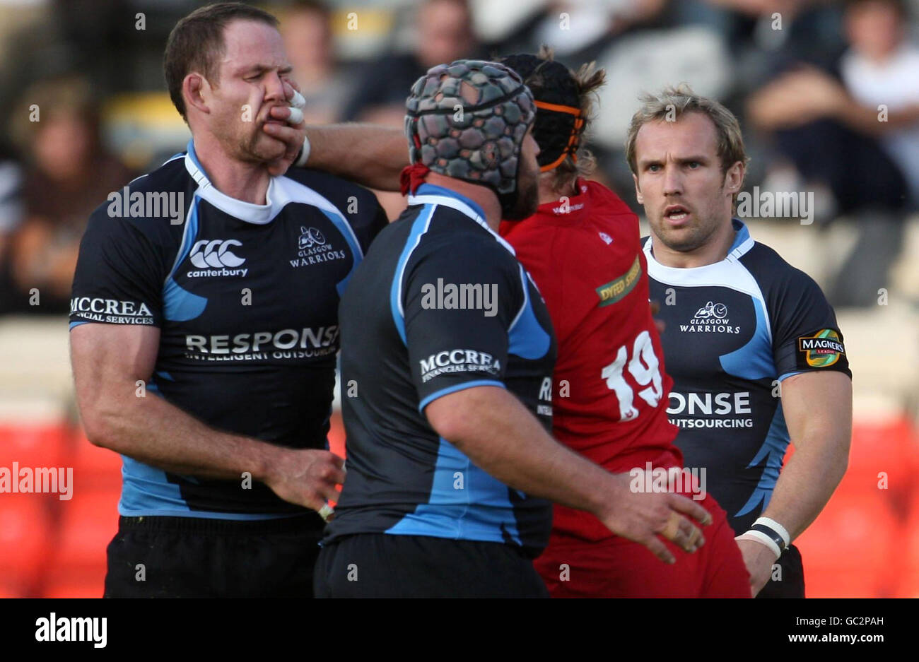 Glasgow Warriors' Graeme Morrison is pushed in the face by Llanelli ...