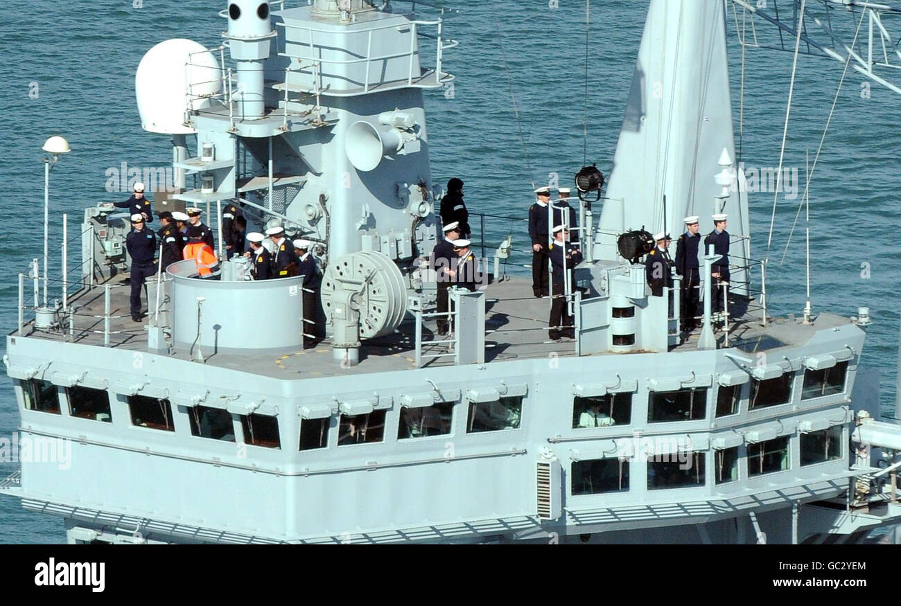 Members of the crew are seen aboard HMS Ark Royal as she takes to the ...