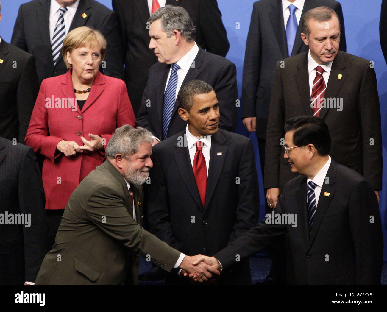 Brazil's President Luiz Inacio Lula da Silva (bottom left) reaches past ...