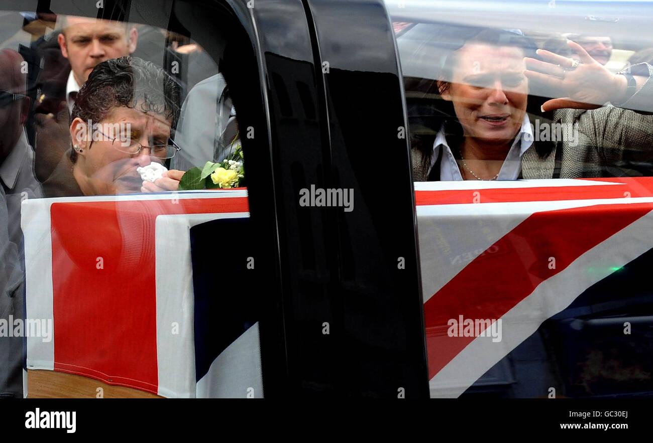 Jane Perrin (left) looks on as the coffin of Acting Sergeant Michael ...