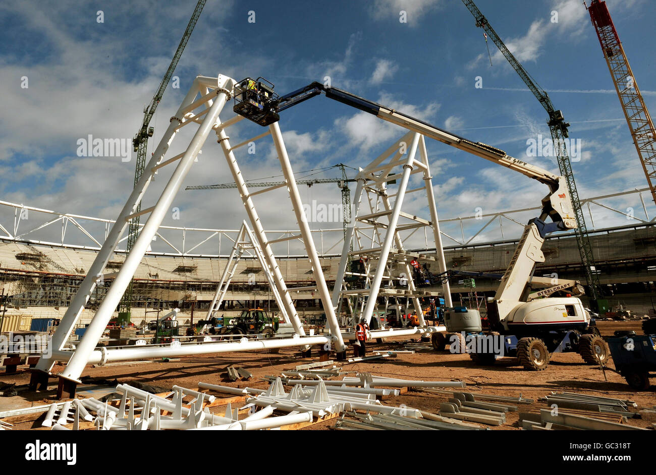 Builders work on the floodlight support structure hi-res stock ...