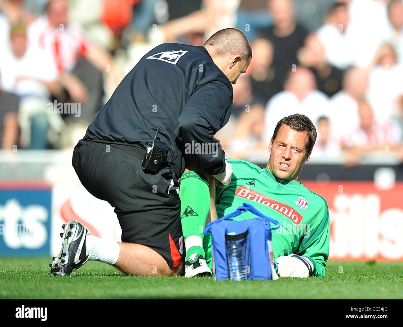 Stoke City goalkeeper Thomas Sorensen recieves treatment on an injury ...