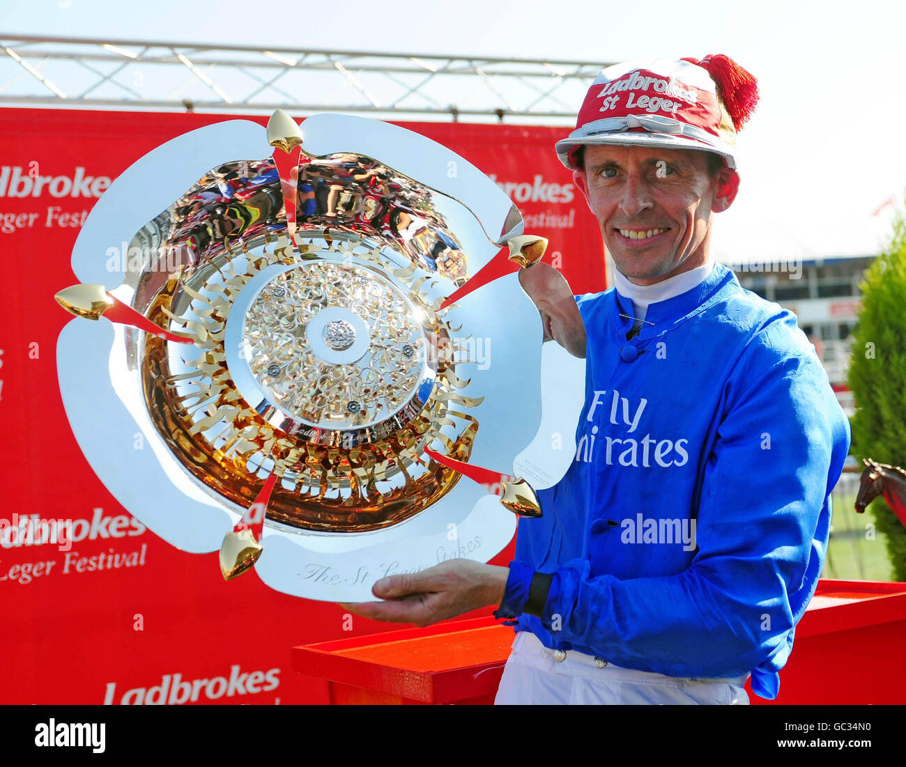 Jockey Ted Durcan with the winners cap and trophy after his victory on ...