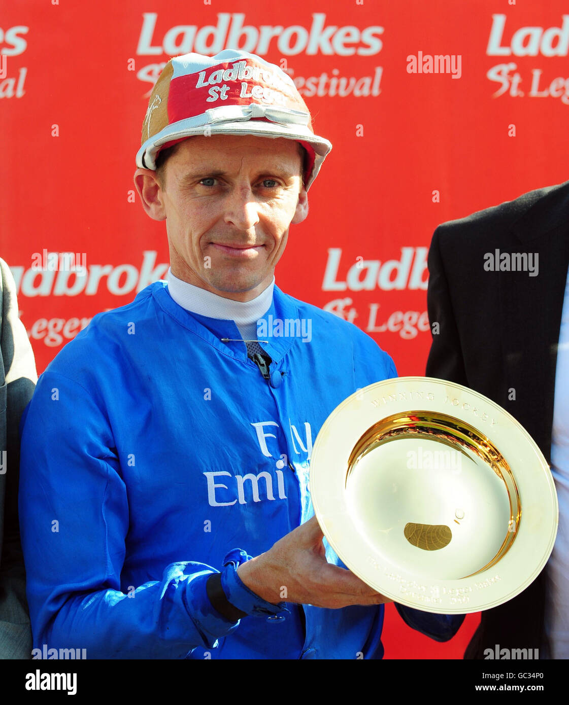 Jockey Ted Durcan with the winners cap and jockey's trophy after his ...