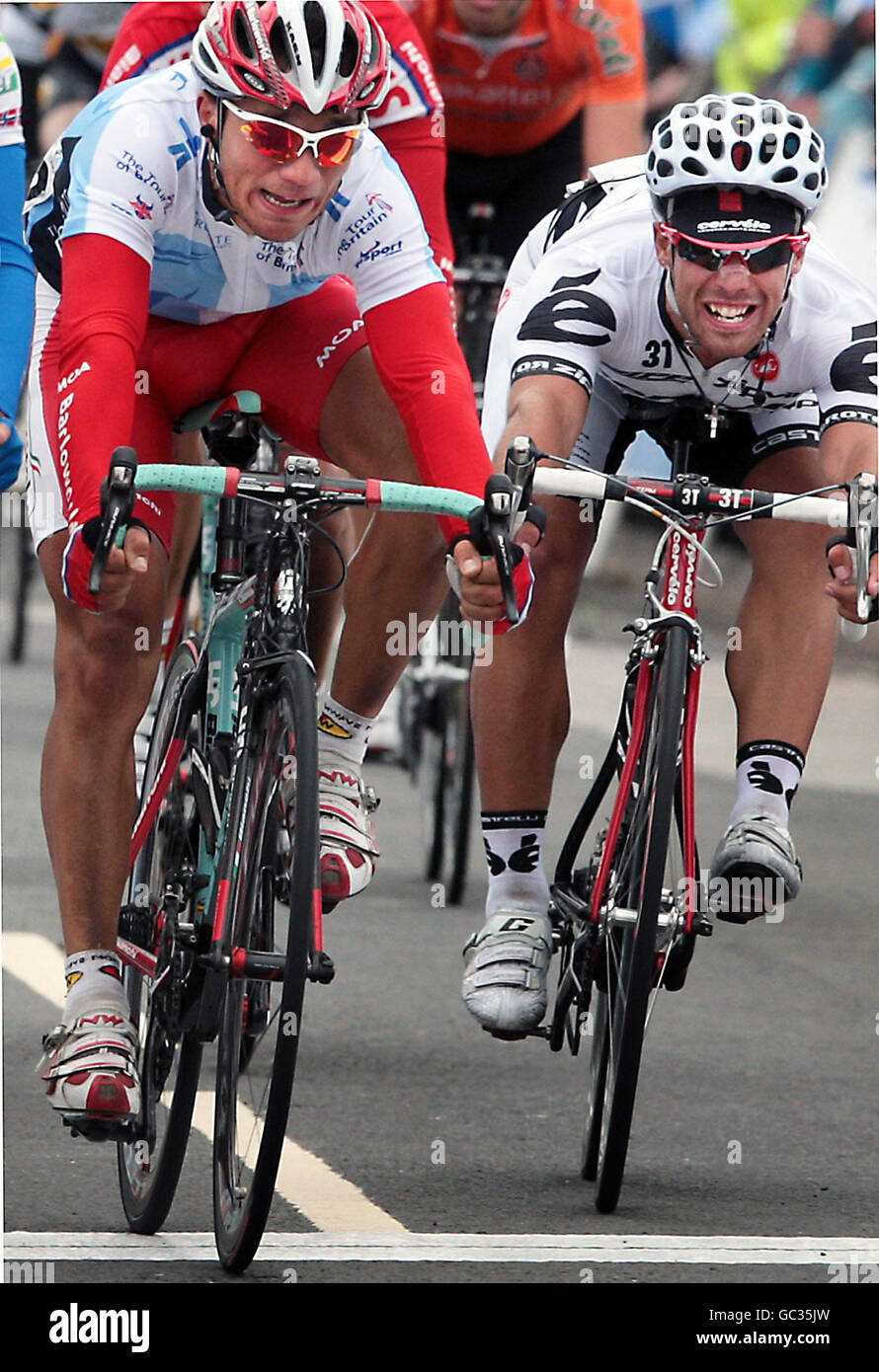 Riders cross the finish line of stage three of the Tour of Britain ...