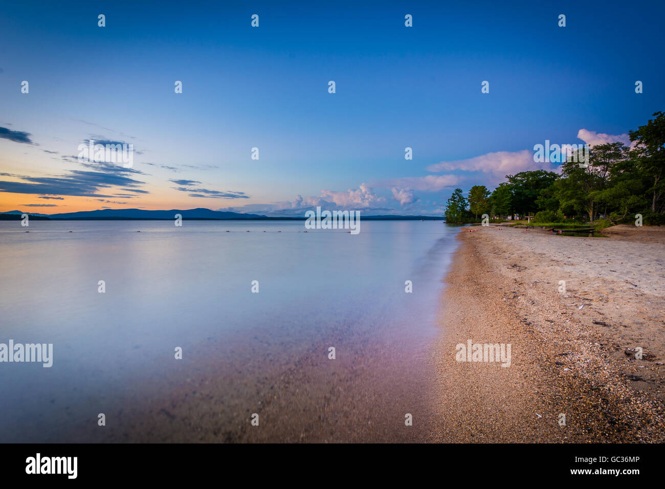 The shore of Lake Winnipesaukee at sunset, at Ellacoya State Park, in ...