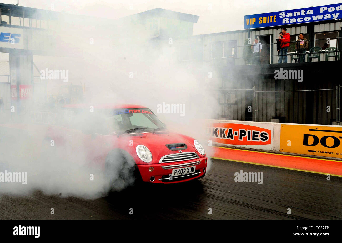 A Mini driver prepares to race against a UK police Subaru Impreza WRX ...