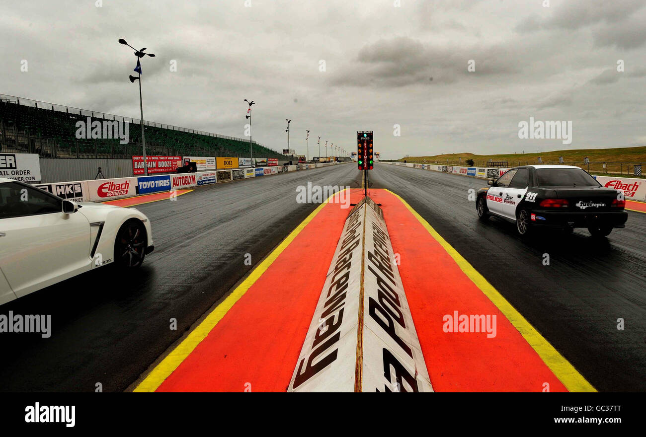 A driver prepares to race against a UK police Subaru Impreza WRX, right ...