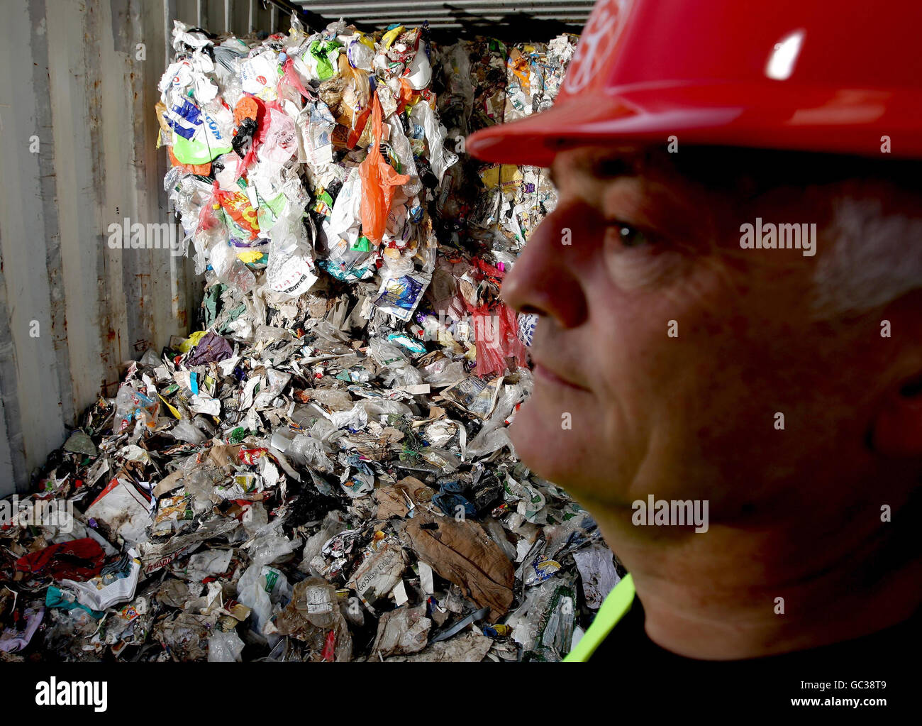 An Environment Agency worker inspects a shipping container filled with ...