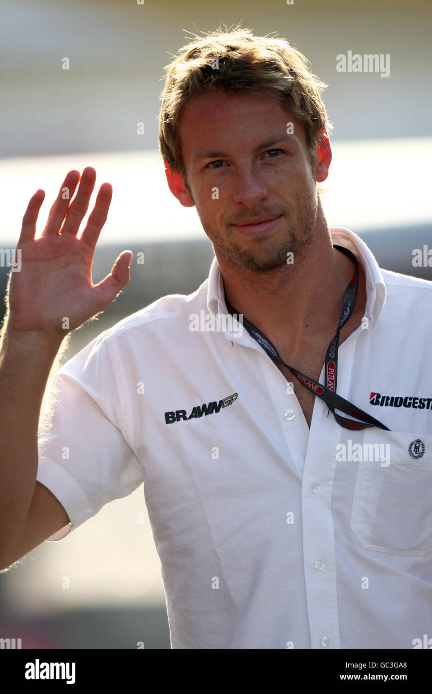 Brawn GP driver Jenson Button arrives in the paddock for first practice ...
