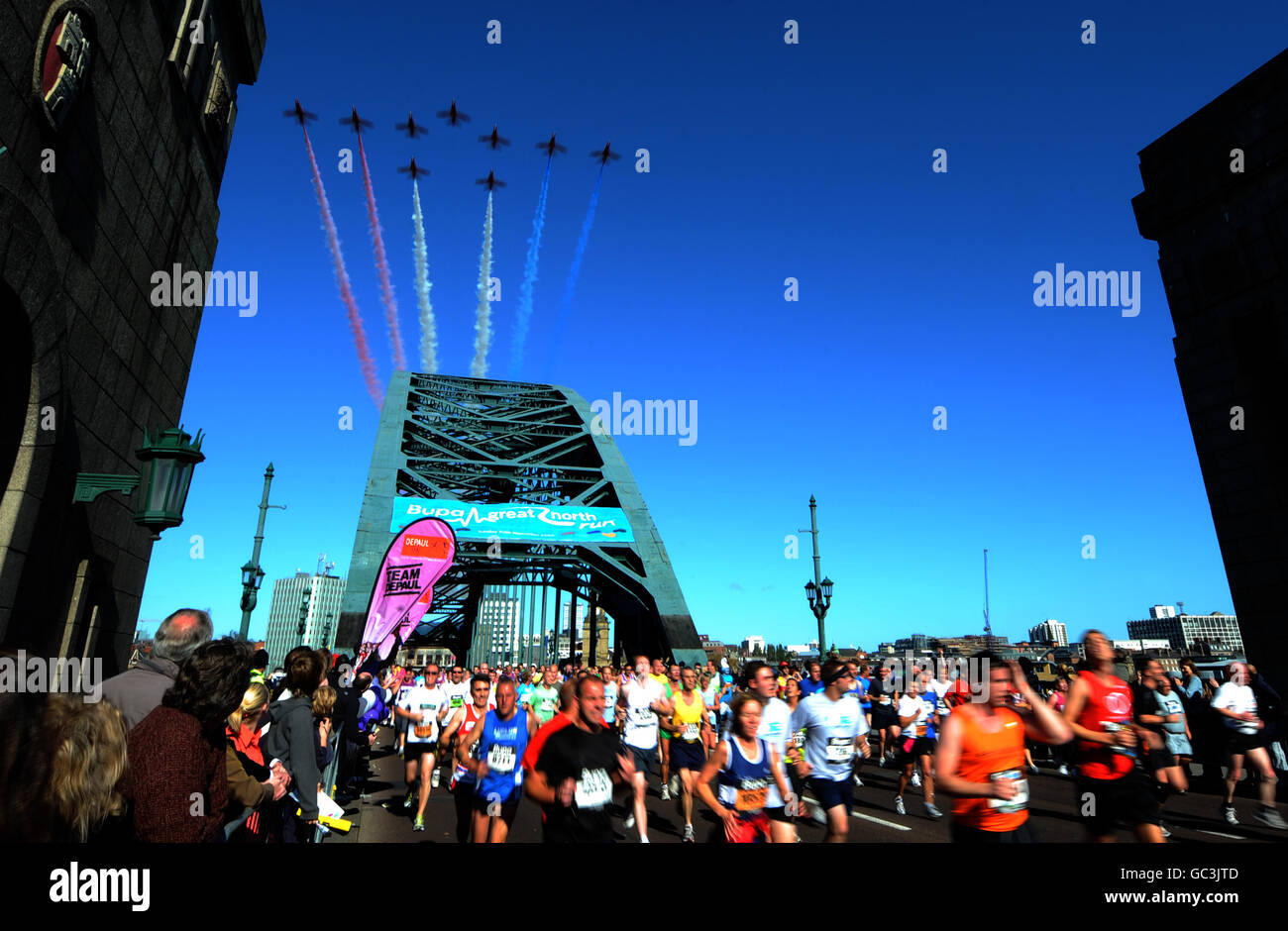 Runners compete in the BUPA Great North Run as the Red Arrows fly over ...