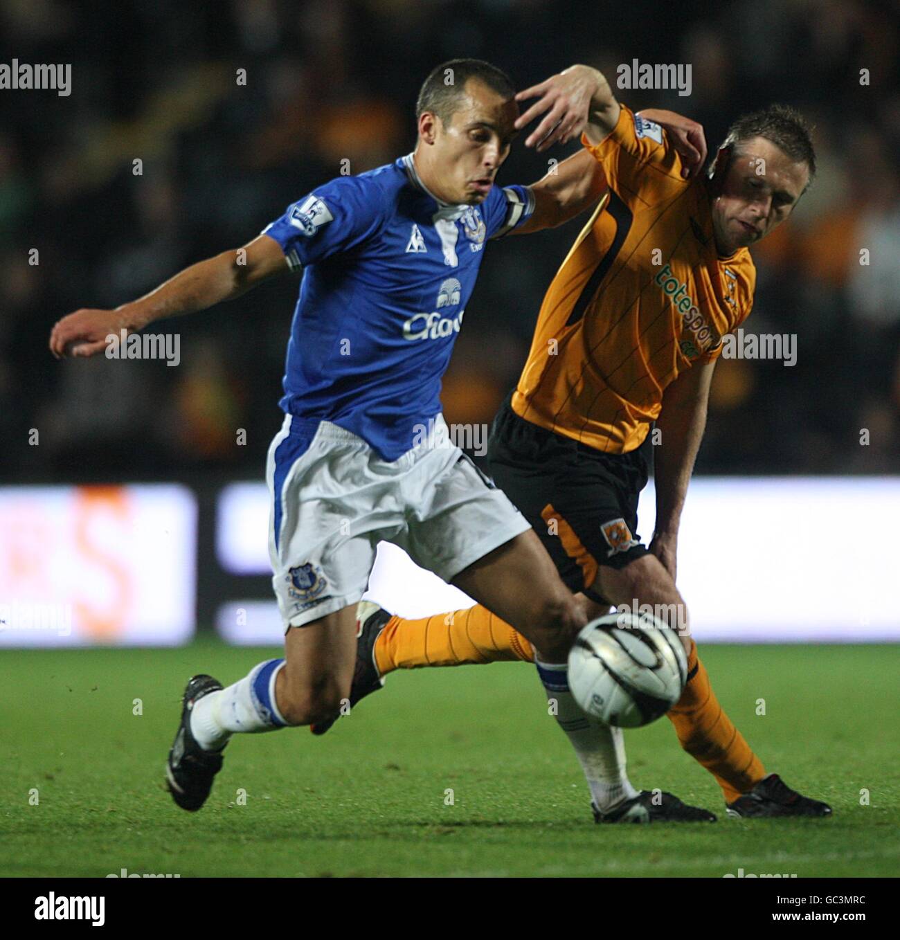 Everton's Leon Osman (left) and Hull City's Nick Barmby batlte for the ...