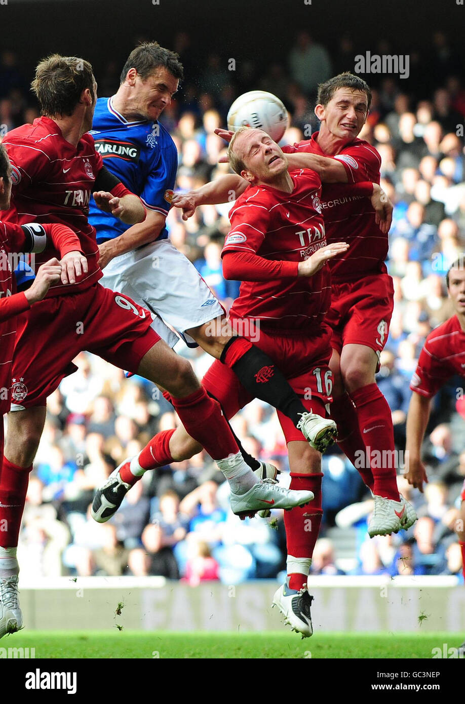 Rangers' Lee McCulloch (c) battles for the ball with Aberdeen's Stuart ...