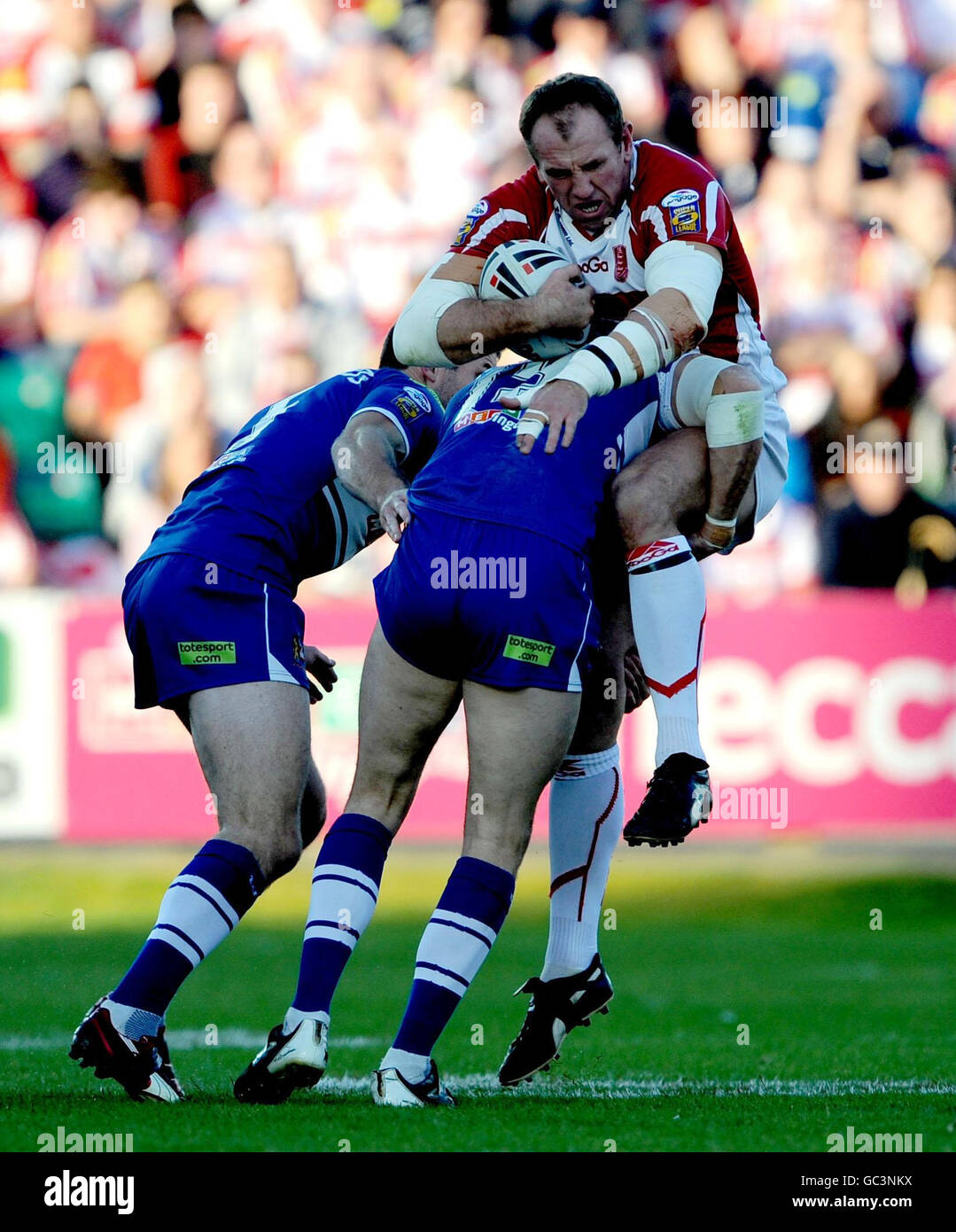 Hull Kingston Rover's Nick Fozzard is lifted up in the air by Wigan ...