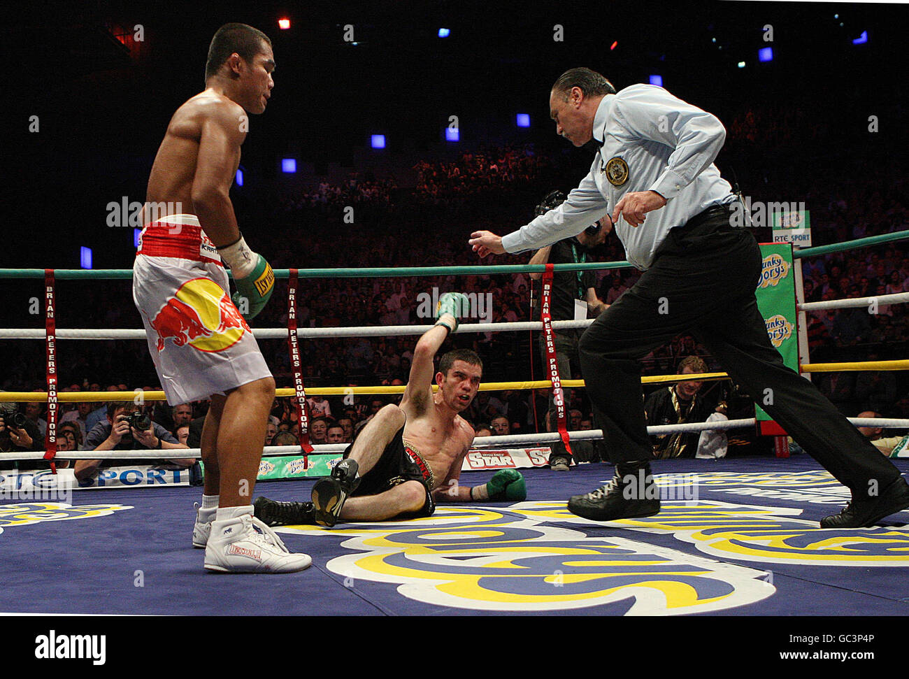 Ireland's Bernard Dunne is knocked down by Poonsawat Kratingdaenggym ...