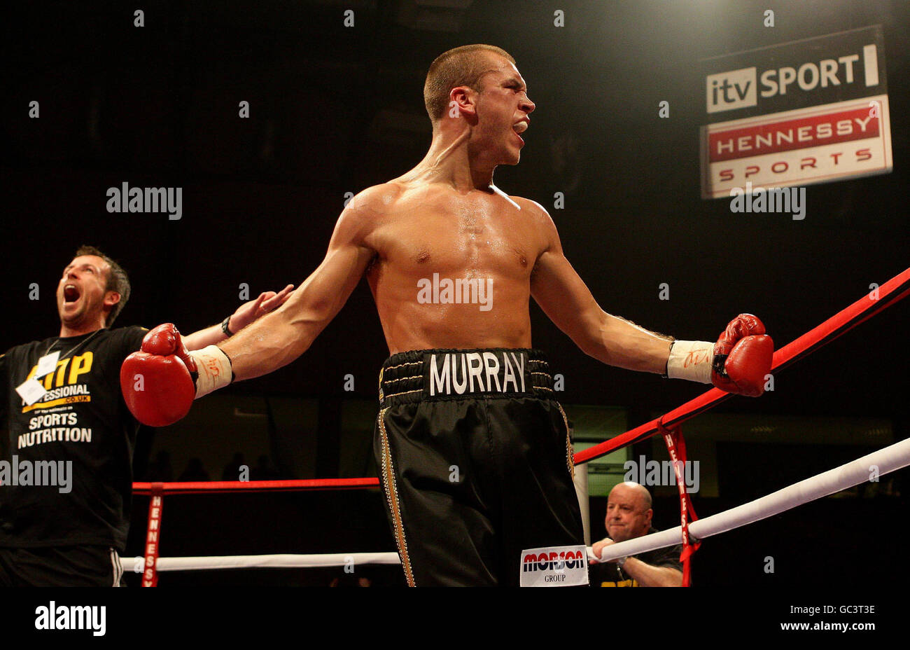 John Murray celebrates defeating Jon Thaxton with trainer Joe Gallagher ...