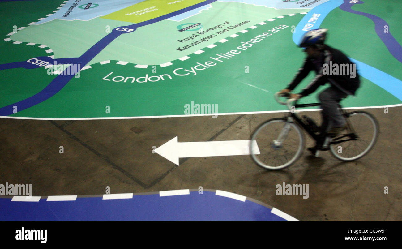 A man cycles on a map showing the new routes of the London Cycle Hire ...