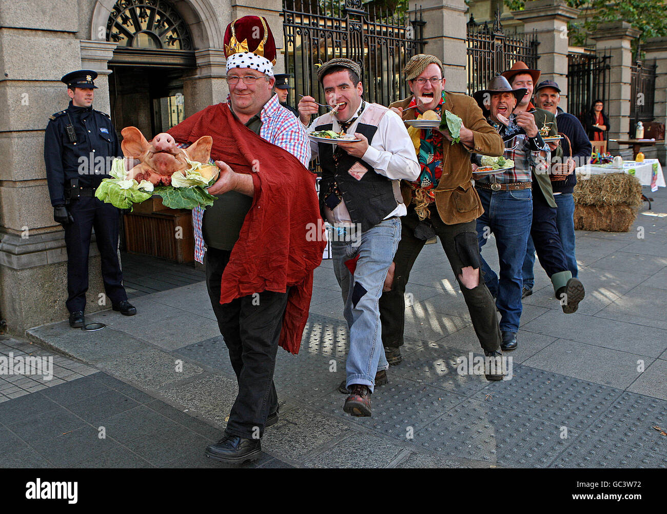 'Culchies' carry a pigs head past Gardai outside the Dail at the launch ...