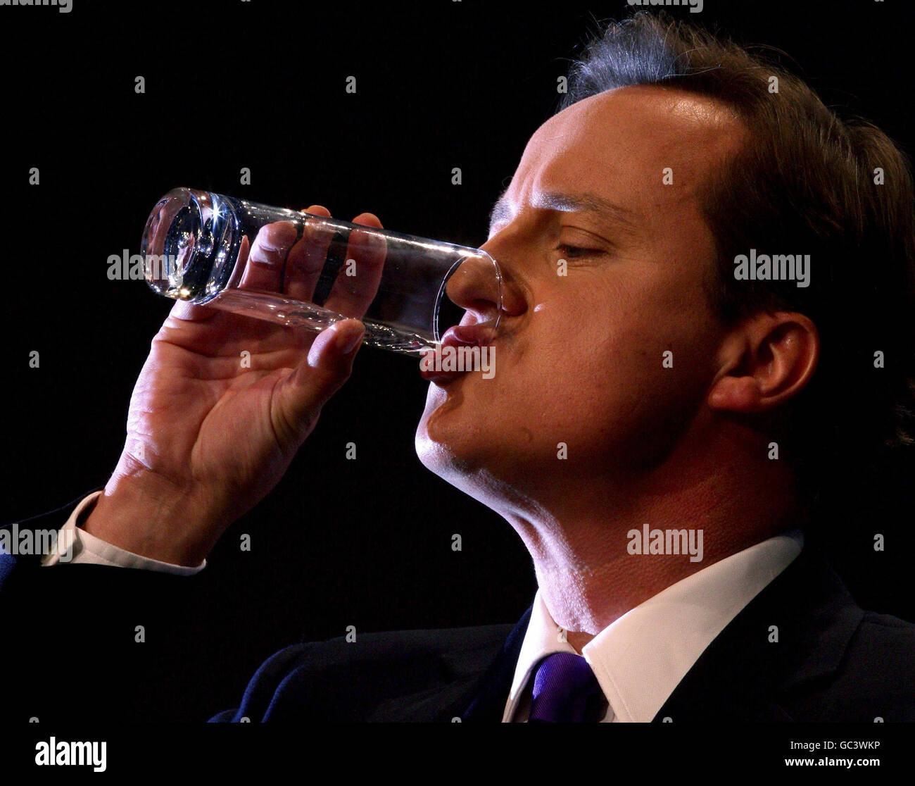 Conservative Party leader David Cameron drinks from a glass as he ...