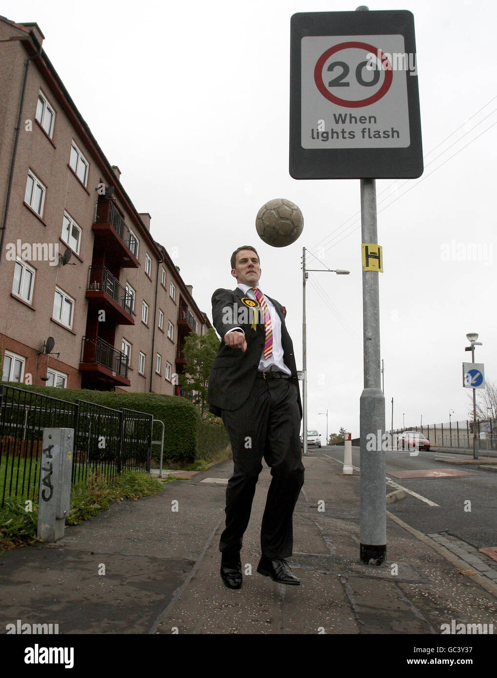 SNP candidate David Kerr kicks a football in the streets of the Milton ...