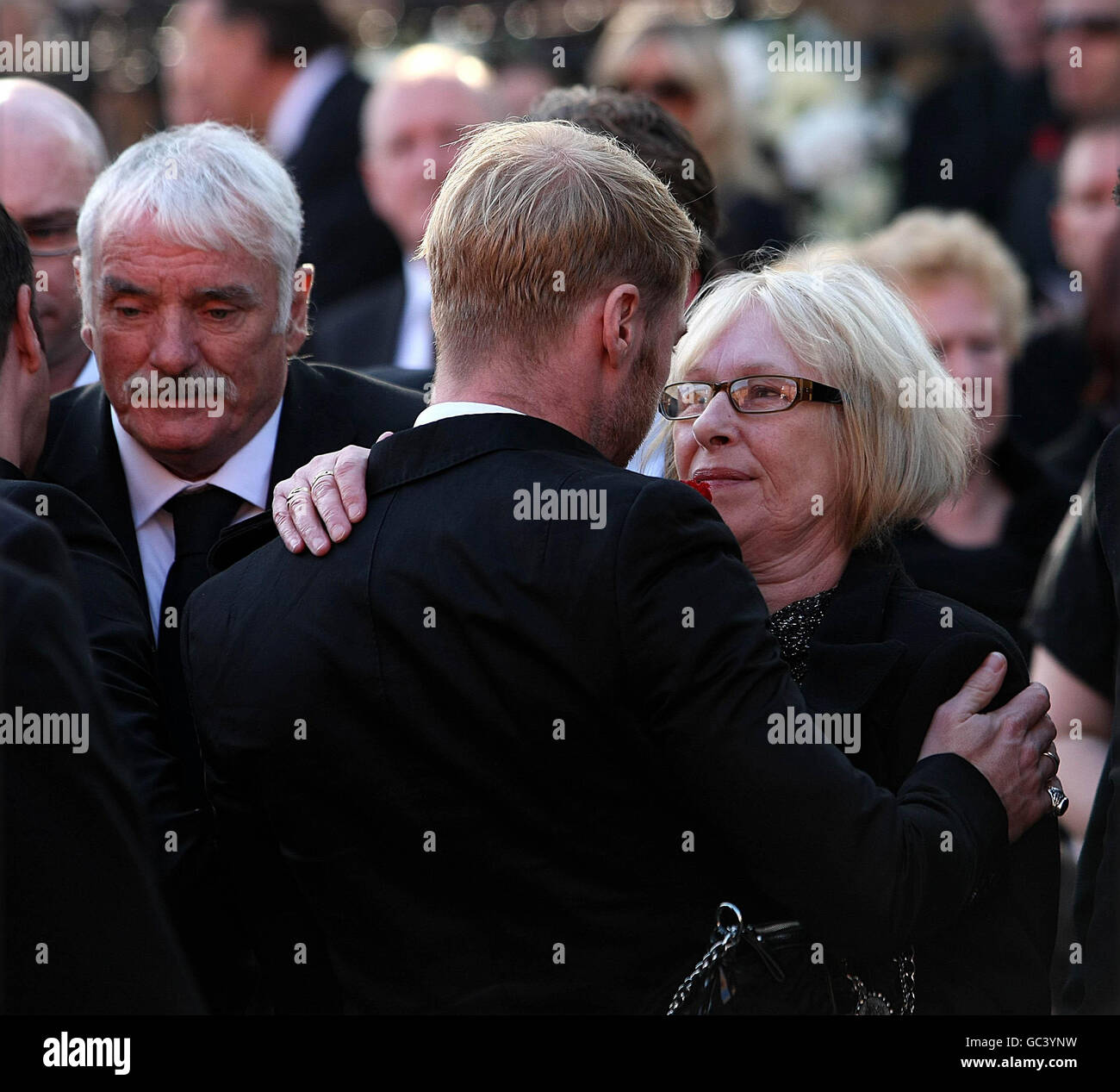 Margaret Gately is comforted by Ronan Keating outside St Laurence O ...