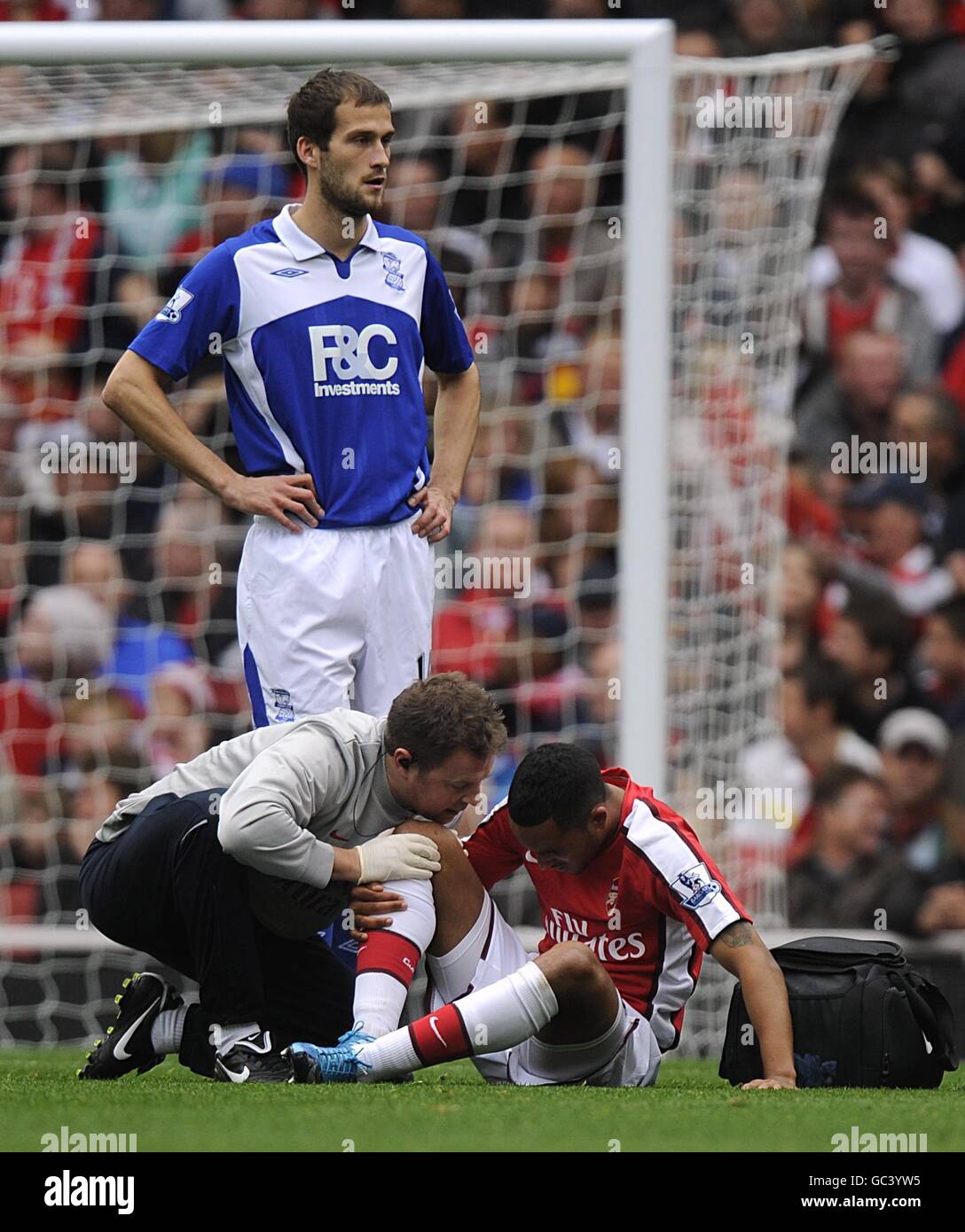 Arsenals theo walcott receives treatment on an injury hi-res stock ...