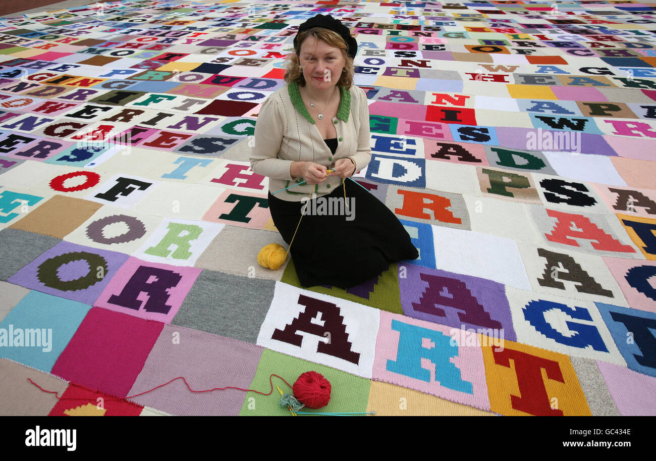 Poetry Society Director Judith Palmer relaxes on a giant knitted poem ...