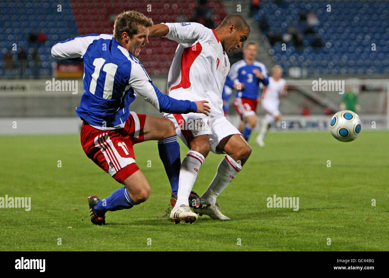 Wales Jermaine Easter holds off Liechtenstein's Lucas Eberie during the ...