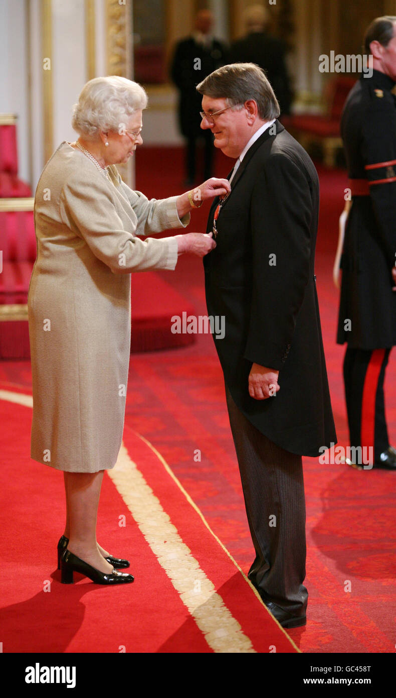 David Moar is made an MBE by Britain's Queen Elizabeth II during an ...