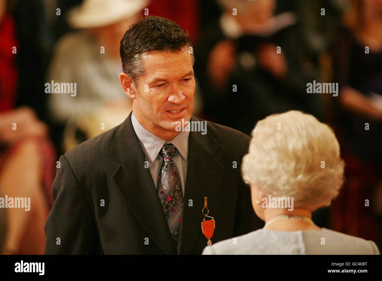 Receives an mbe from the queen at buckingham palace hi-res stock ...