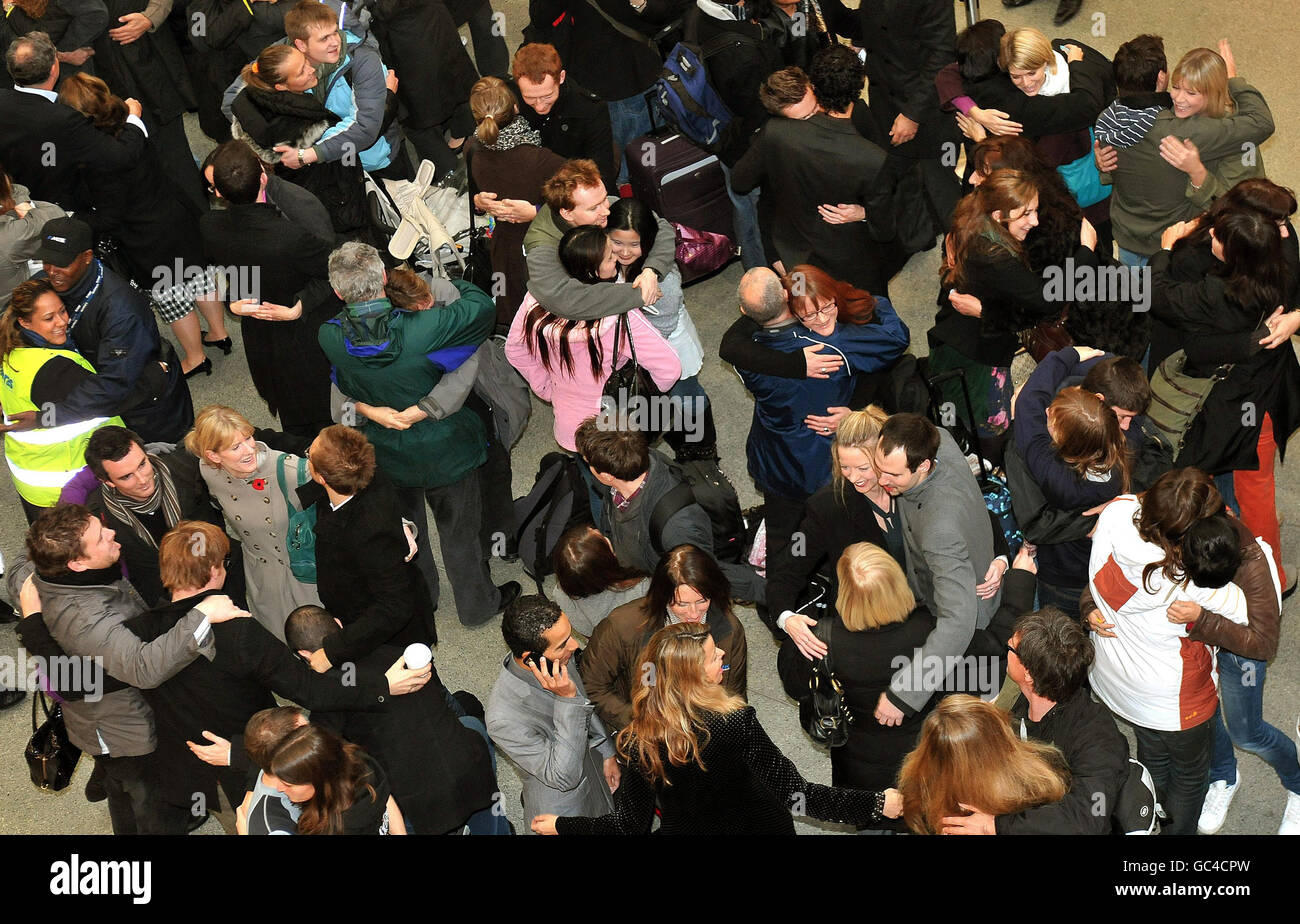 A large group of people hug each other for one minute, in an attempt to ...