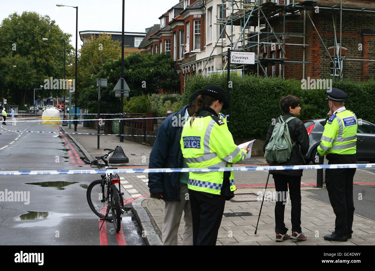 Police officers advise local residents as an investigation takes place ...