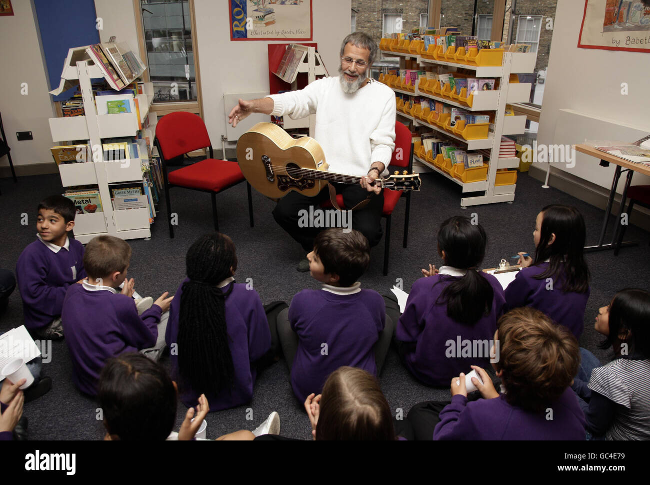 Yusuf Islam visits his old school. Yusuf Islam sings to pupils during ...