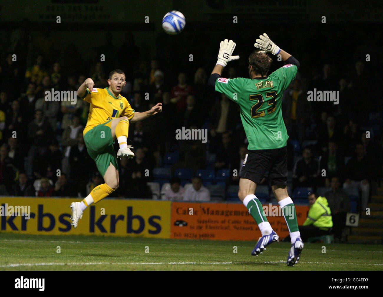 Norwich City's Jamie Cureton attempts to chip the Gillingham goalkeeper ...