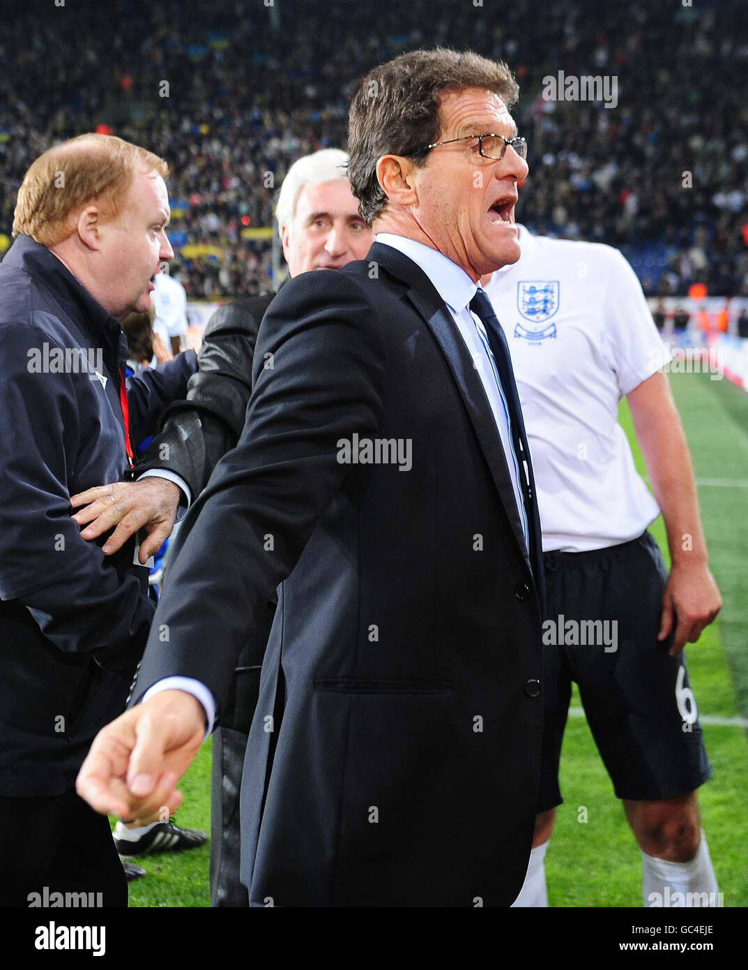 England manager Fabio Capello goes to speak with the referee during the ...