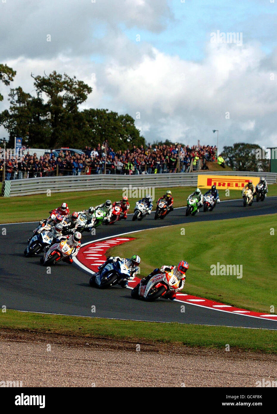 Stuart Eason leads the pack around cascades on the first lap of race 1 ...