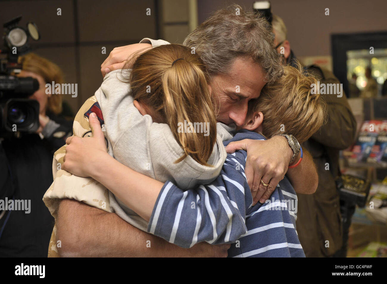 Lieutenant Colonel Nick Richardson gets a big hug from his children ...
