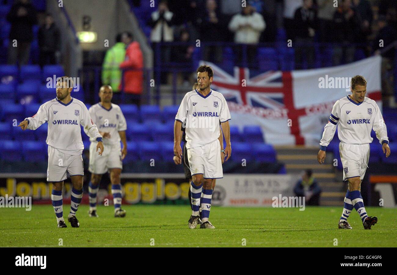 Tranmere Rovers' players stand dejected after Stockport County's Carl ...