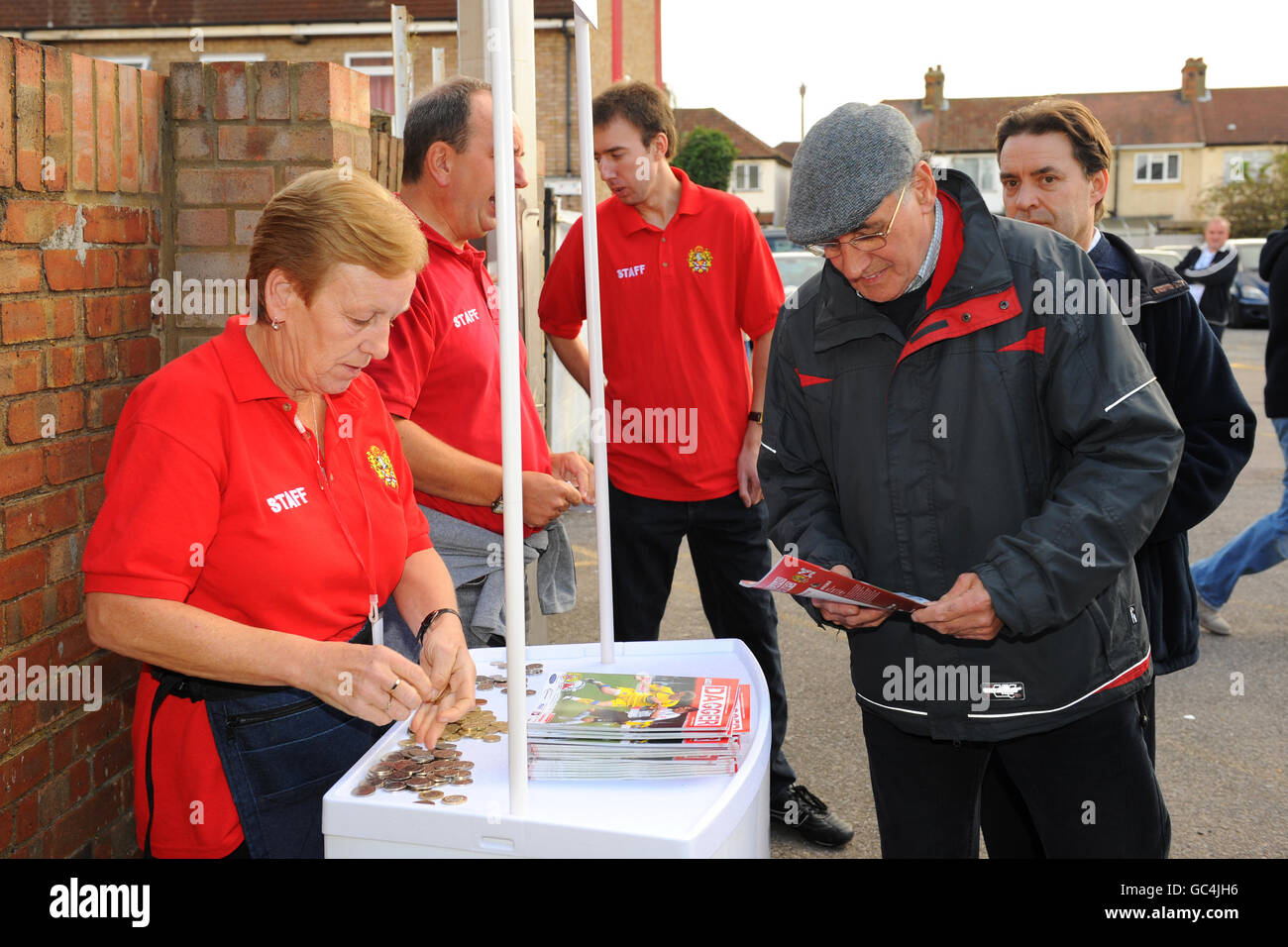 Fans purchase matchday programme from stall outside the ground hi-res ...