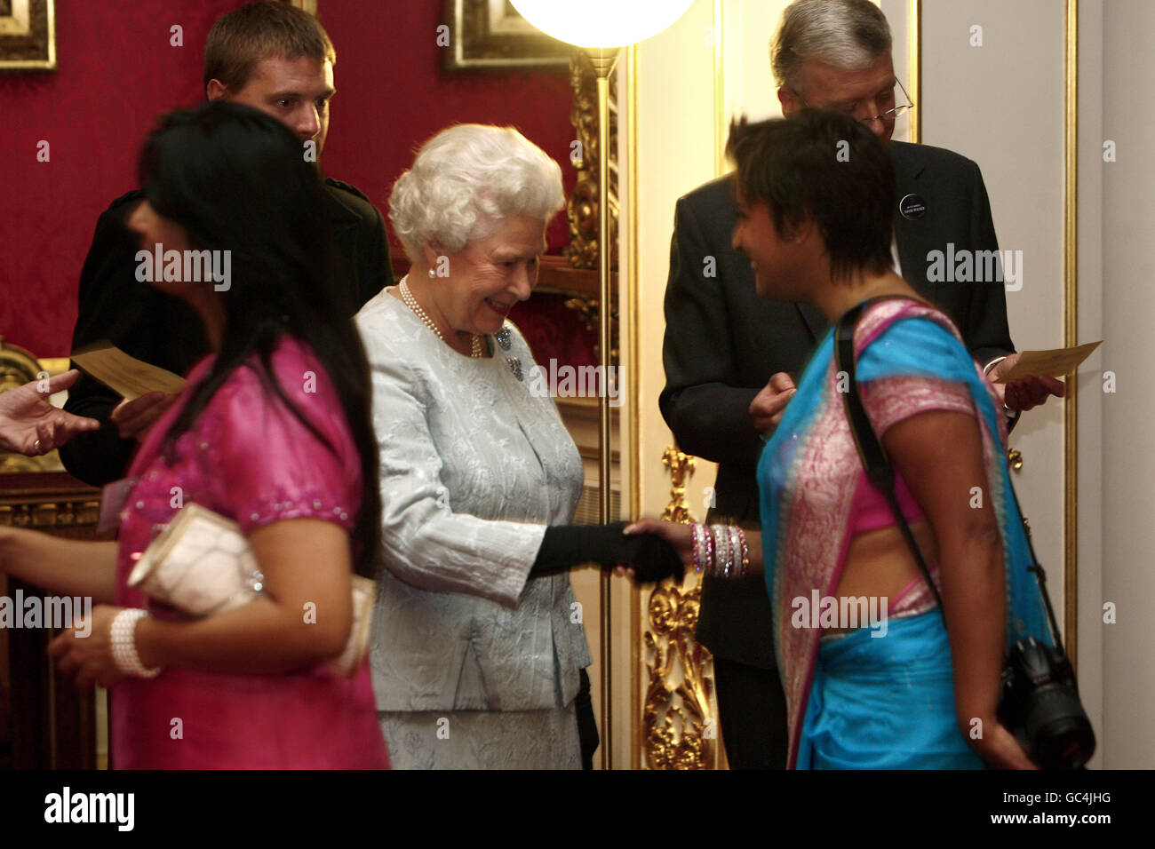 Queen Elizabeth II meets a guest during a reception inside the ballroom ...