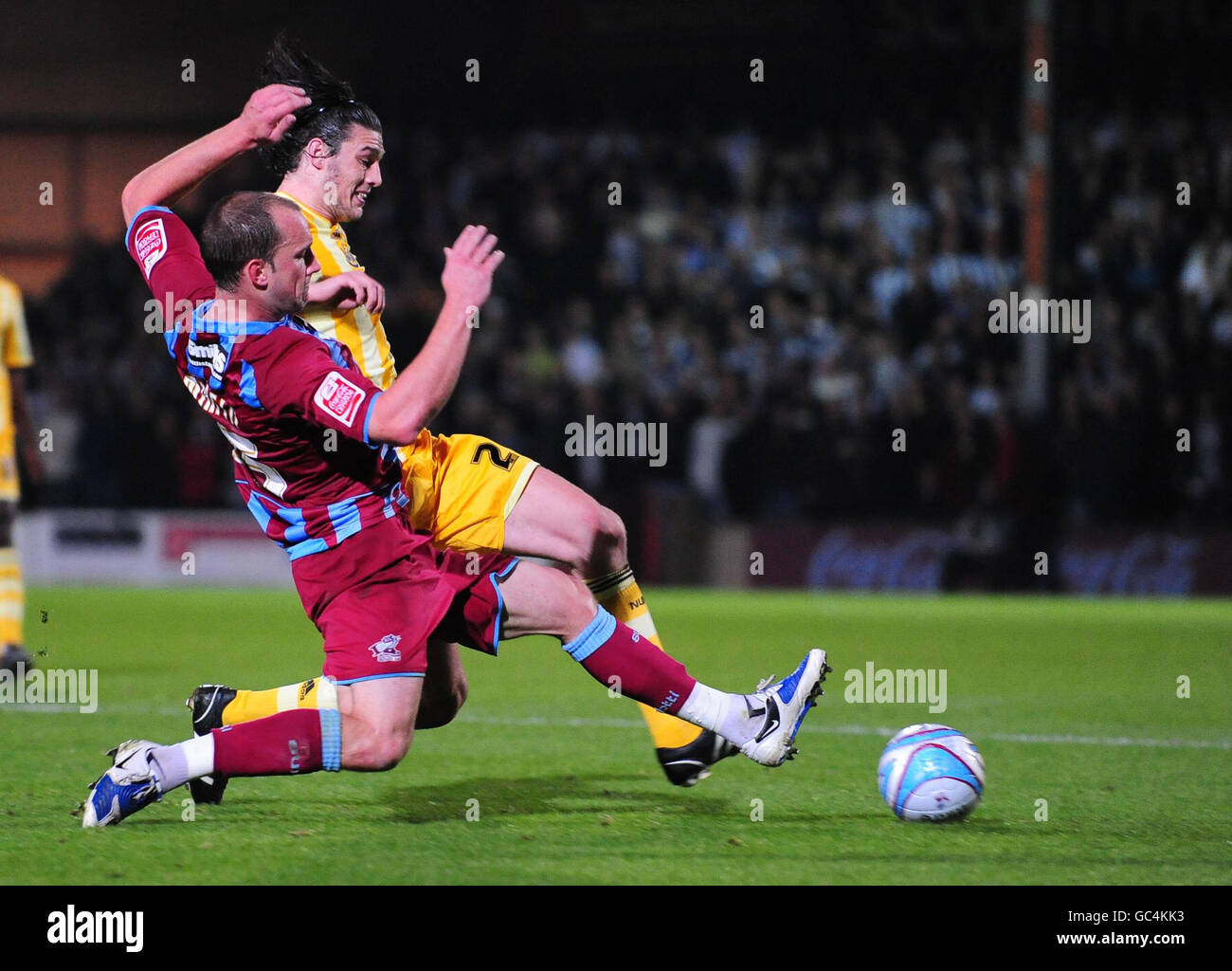 Scunthorpe's David Mirfin (left) and Newcastle United's Andrew Carroll ...