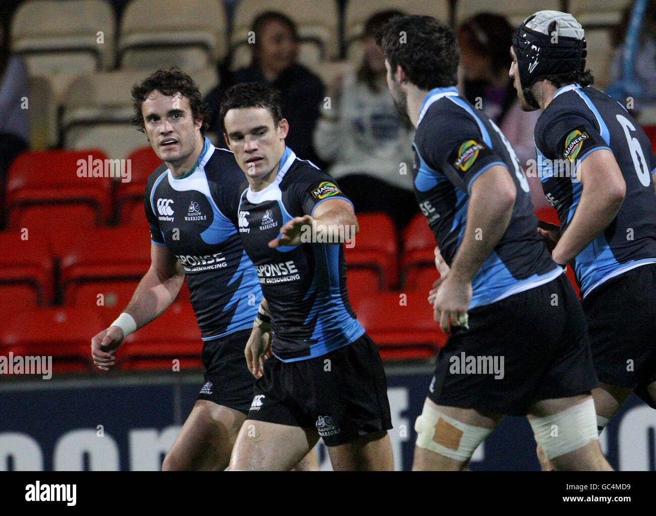 Glasgow's Max Evans (centre) celebrates his try on his comeback with ...
