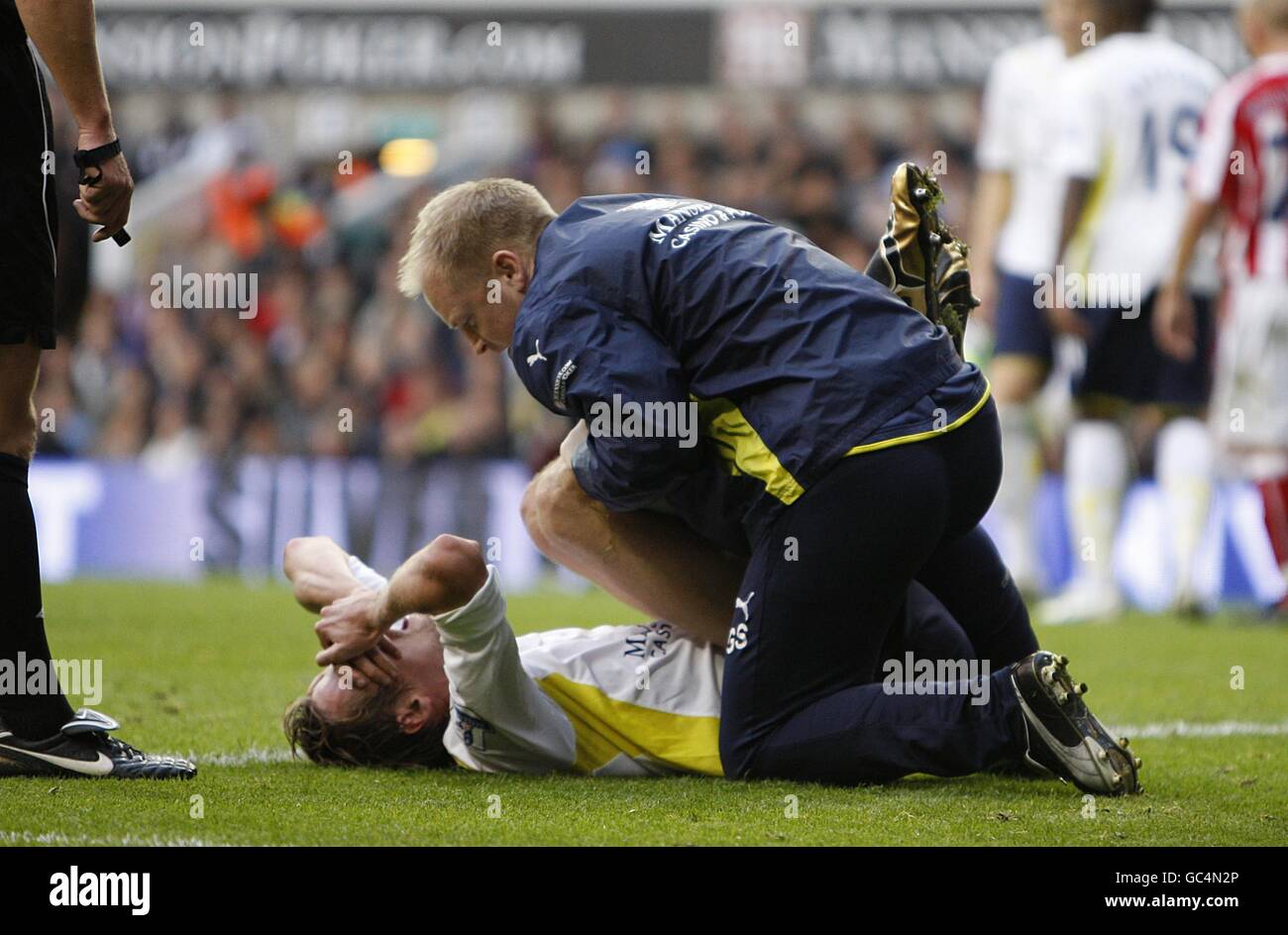 Tottenham Hotspur's Peter Crouch recieves treatment for an injury Stock ...