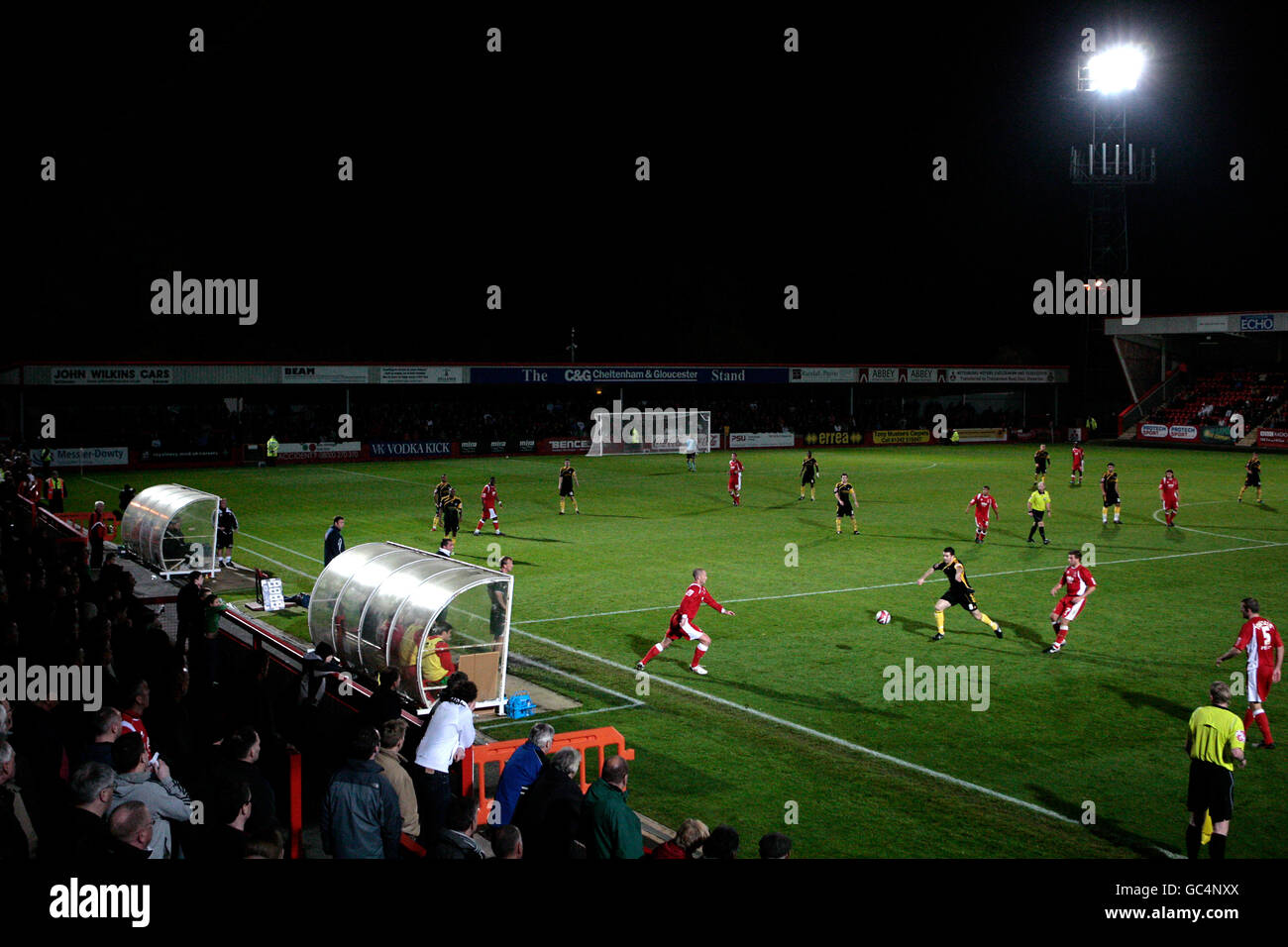 General view of the action being played under floodlights at Whaddon ...