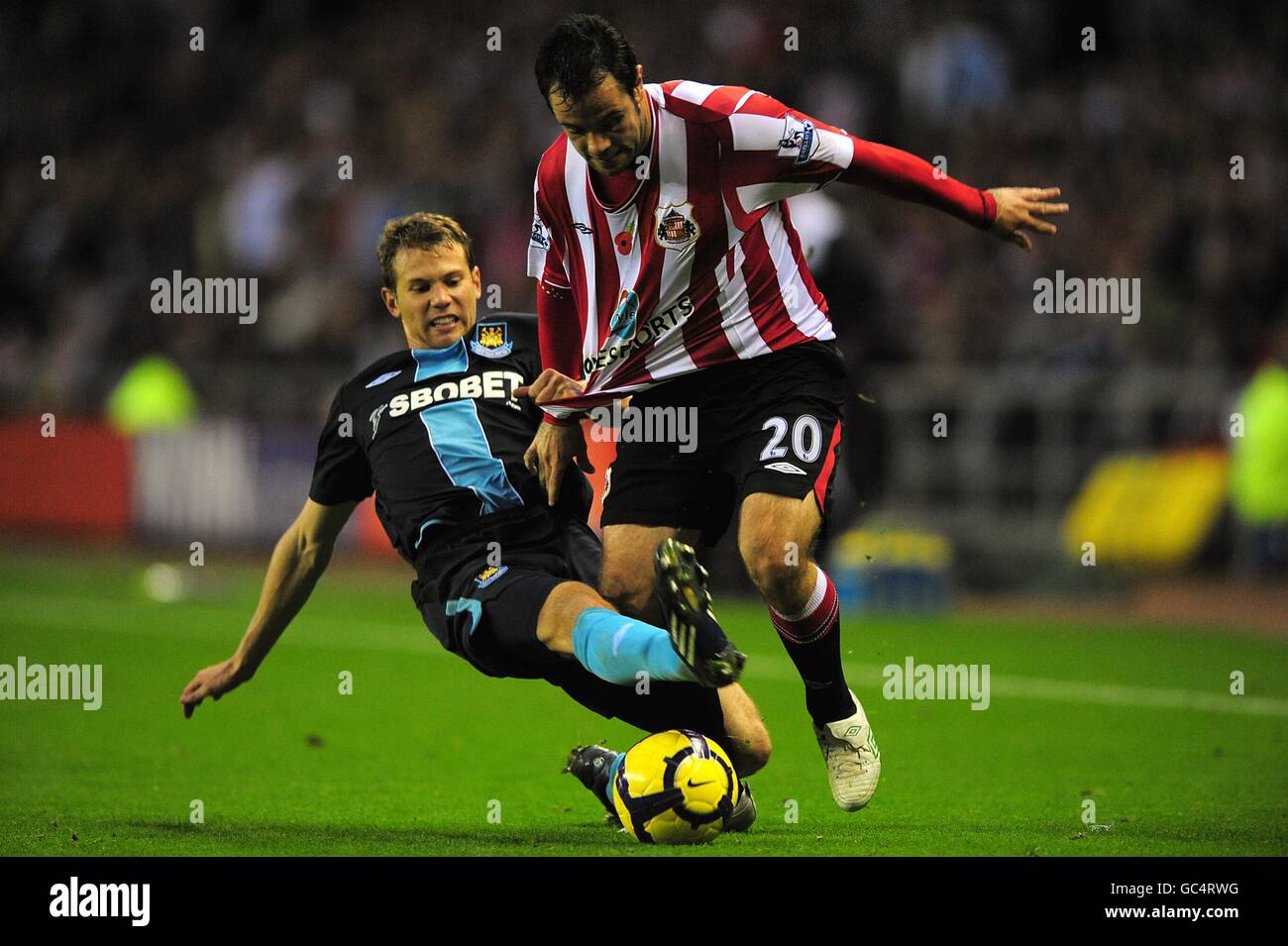 West Ham United's Jonathan Spector (left) and Sunderland's Andy Reid ...