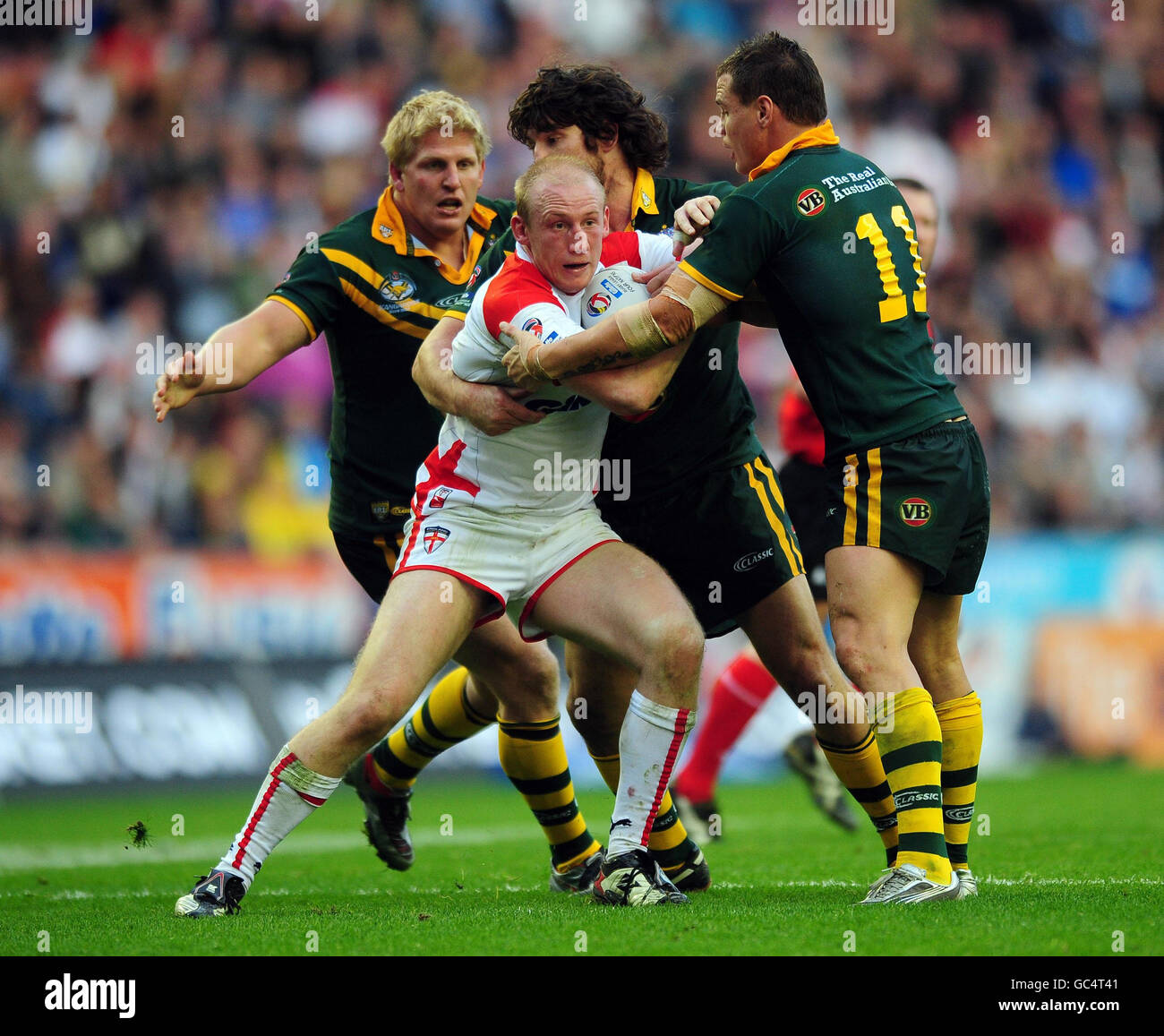 England's Shaun Briscoe is tackled by Australia's (l-r) Petero ...