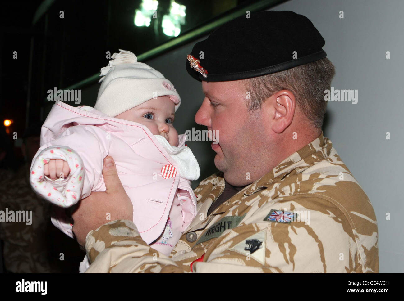Sergeant Darren Wright from the Light Dragoons holds his baby daughter ...
